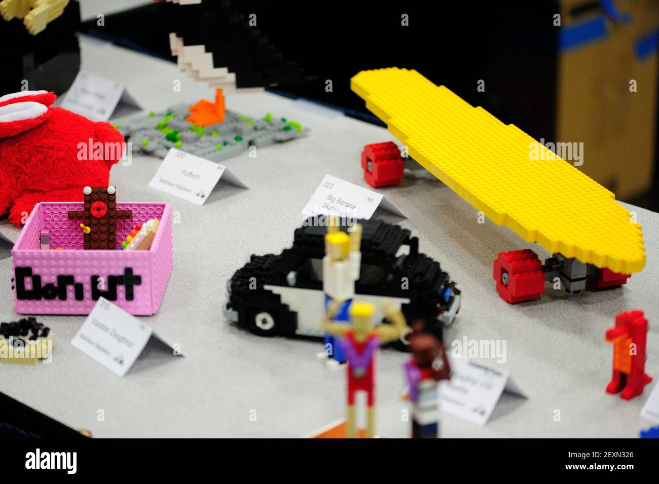 Various Lego creations, including a yellow skateboard, on display at ...