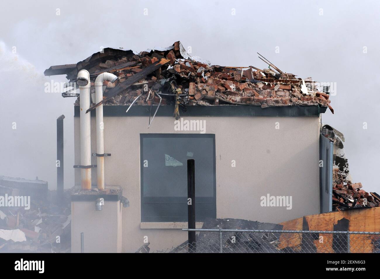 Debris from a building that exploded lays on the roof of an adjacent ...
