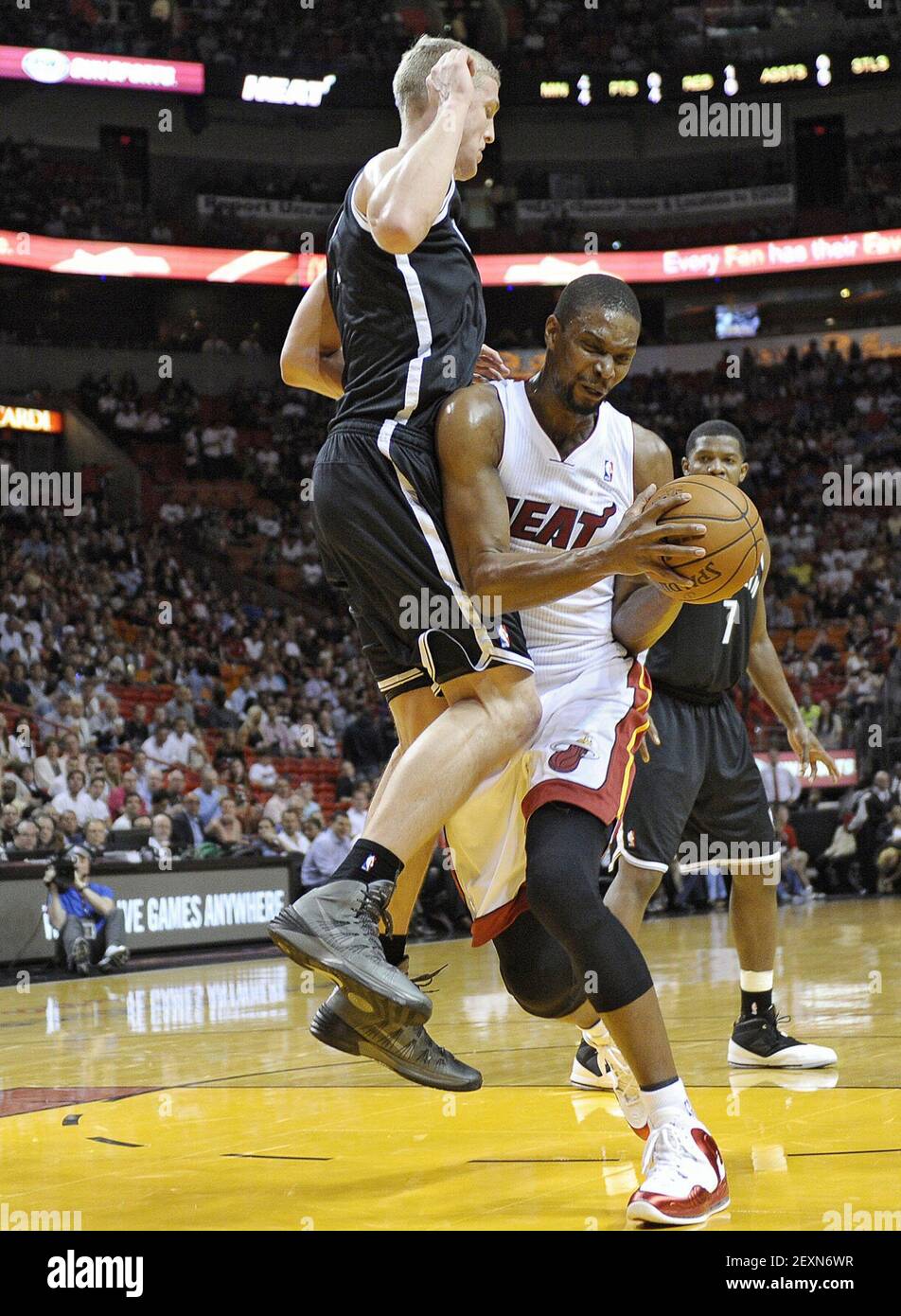 The Miami Heat's Chris Bosh is fouled by the Brooklyn Nets' Mason ...