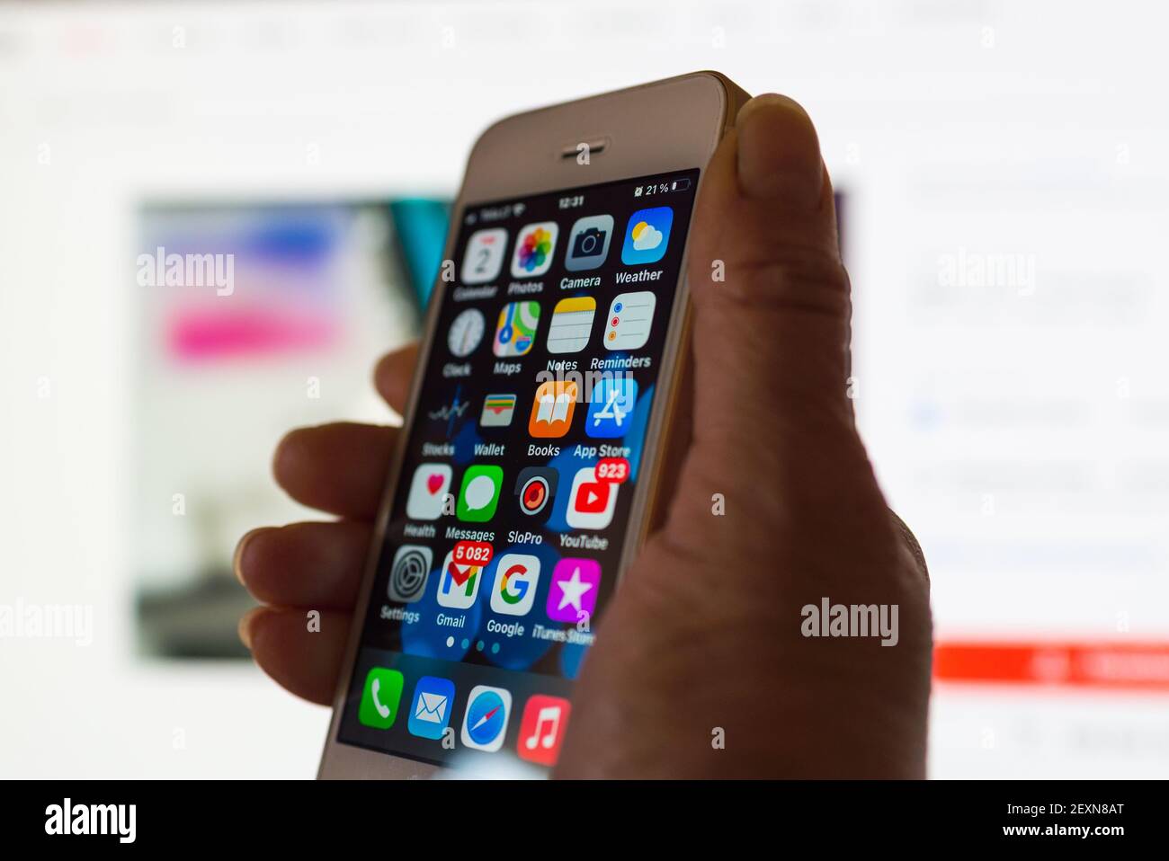 Woman hand showing social media app icons on modern smartphone display ...