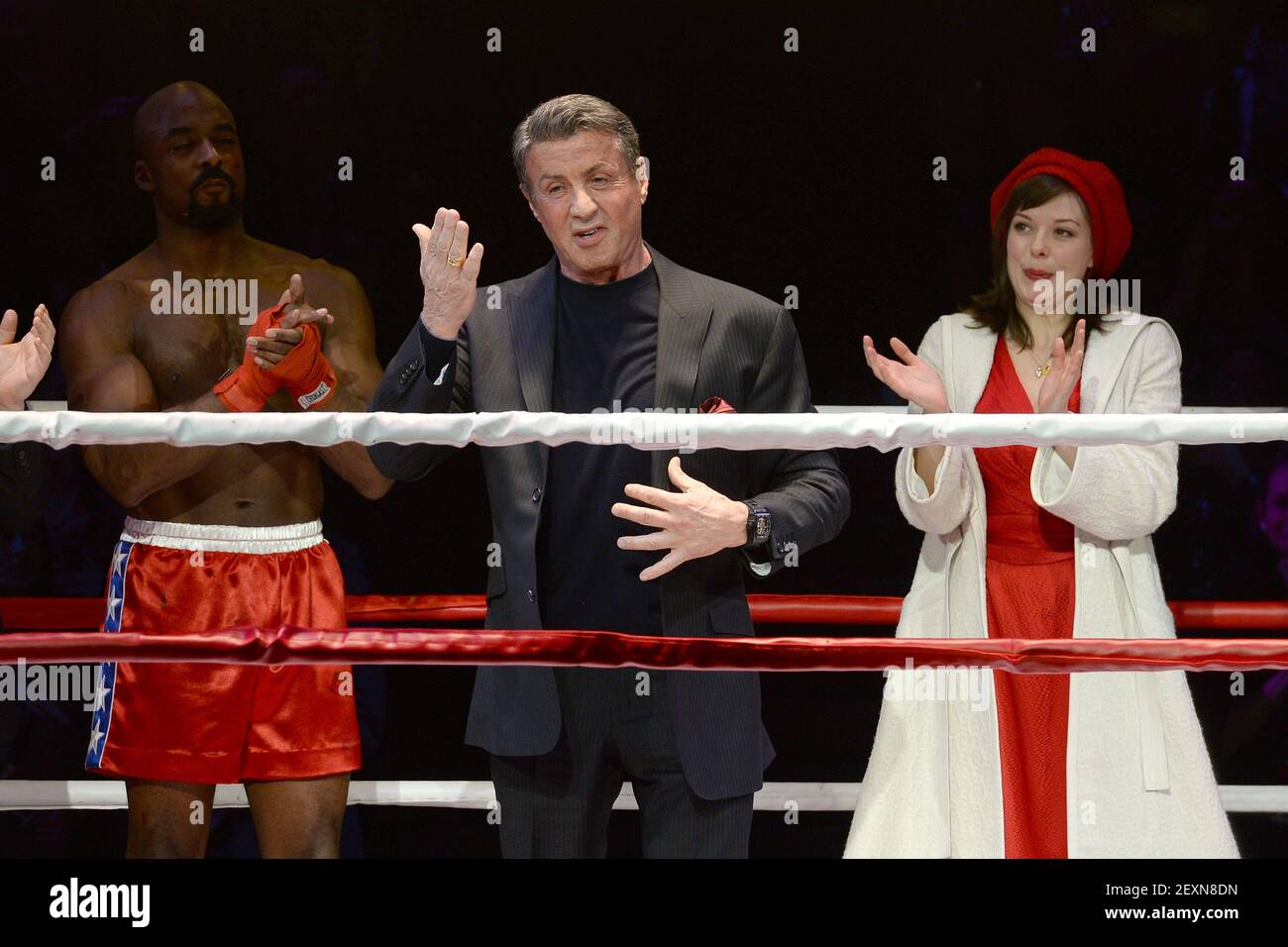 Sylvester Stallone (center) stands in the boxing ring stage set at the ...