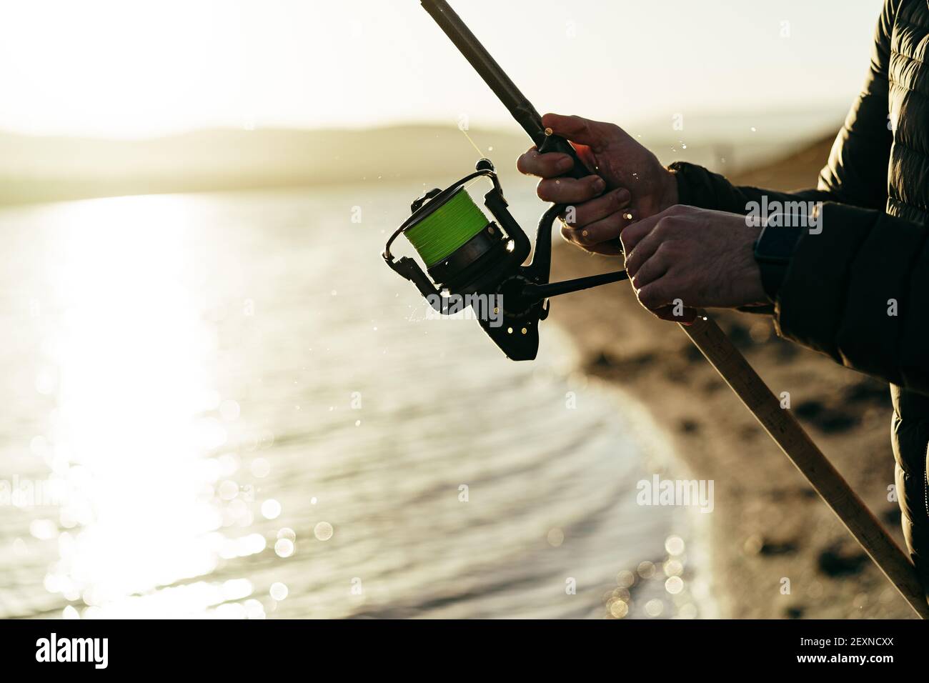 Fisherman hands holding fishing rod close up Stock Photo - Alamy