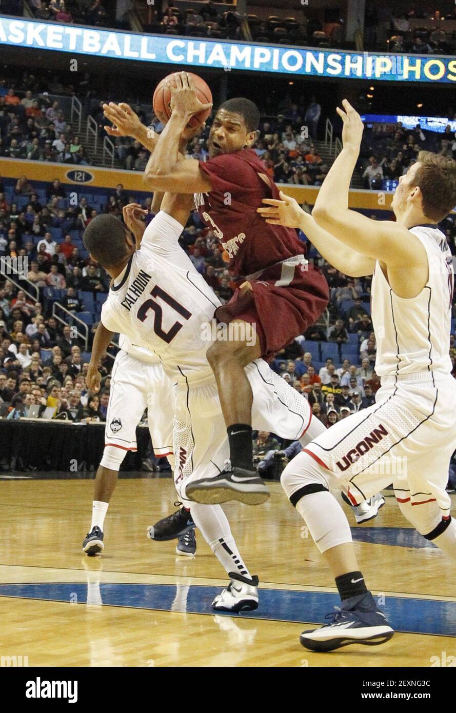Saint Joseph's Ronald Roberts, middle, goes over Connecticut's Omar ...