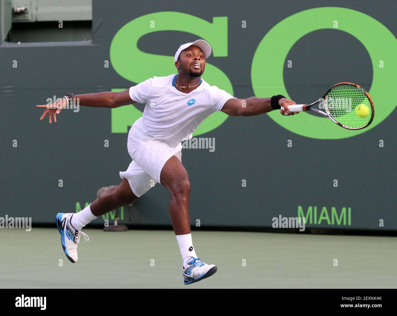 Donald Young of the USA returns a shot against John Isner of the USA ...