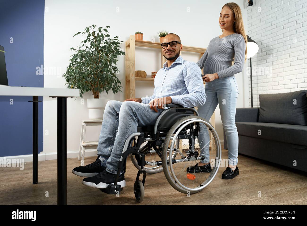 Pregnant woman takes care of her disabled husband in wheelchair Stock ...