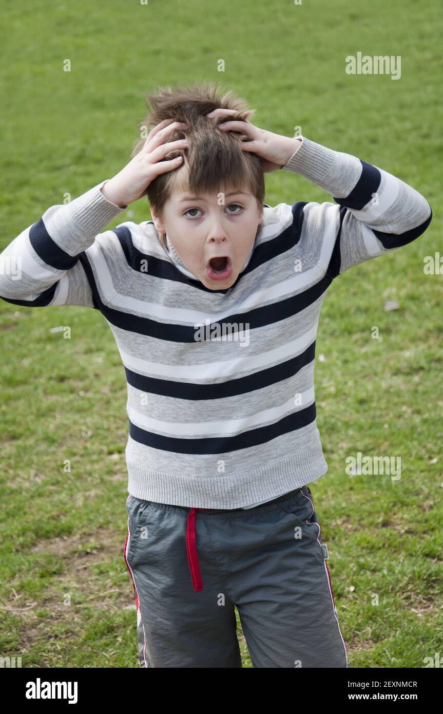 Emotional boy screaming and holding his head Stock Photo - Alamy