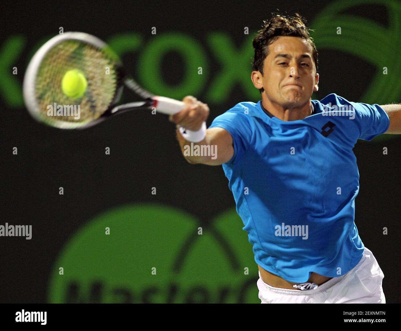 Nicolas Almagro returns a shot in his match with John Isner during the ...