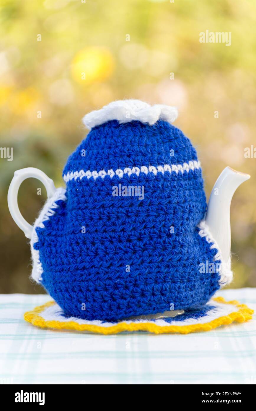 Knitted doily on the teapot in natural background Stock Photo - Alamy