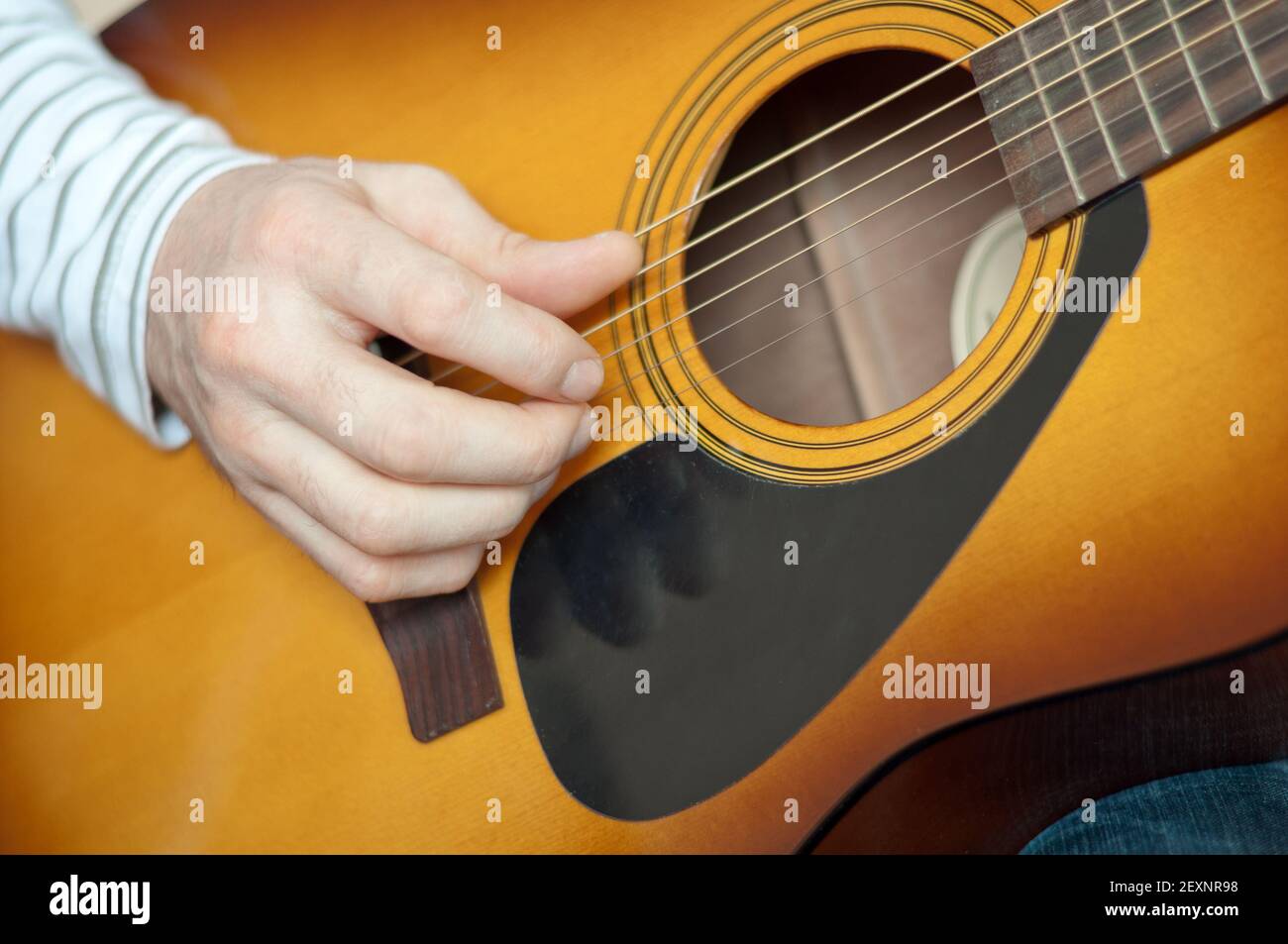A man plays the six string guitar Stock Photo - Alamy