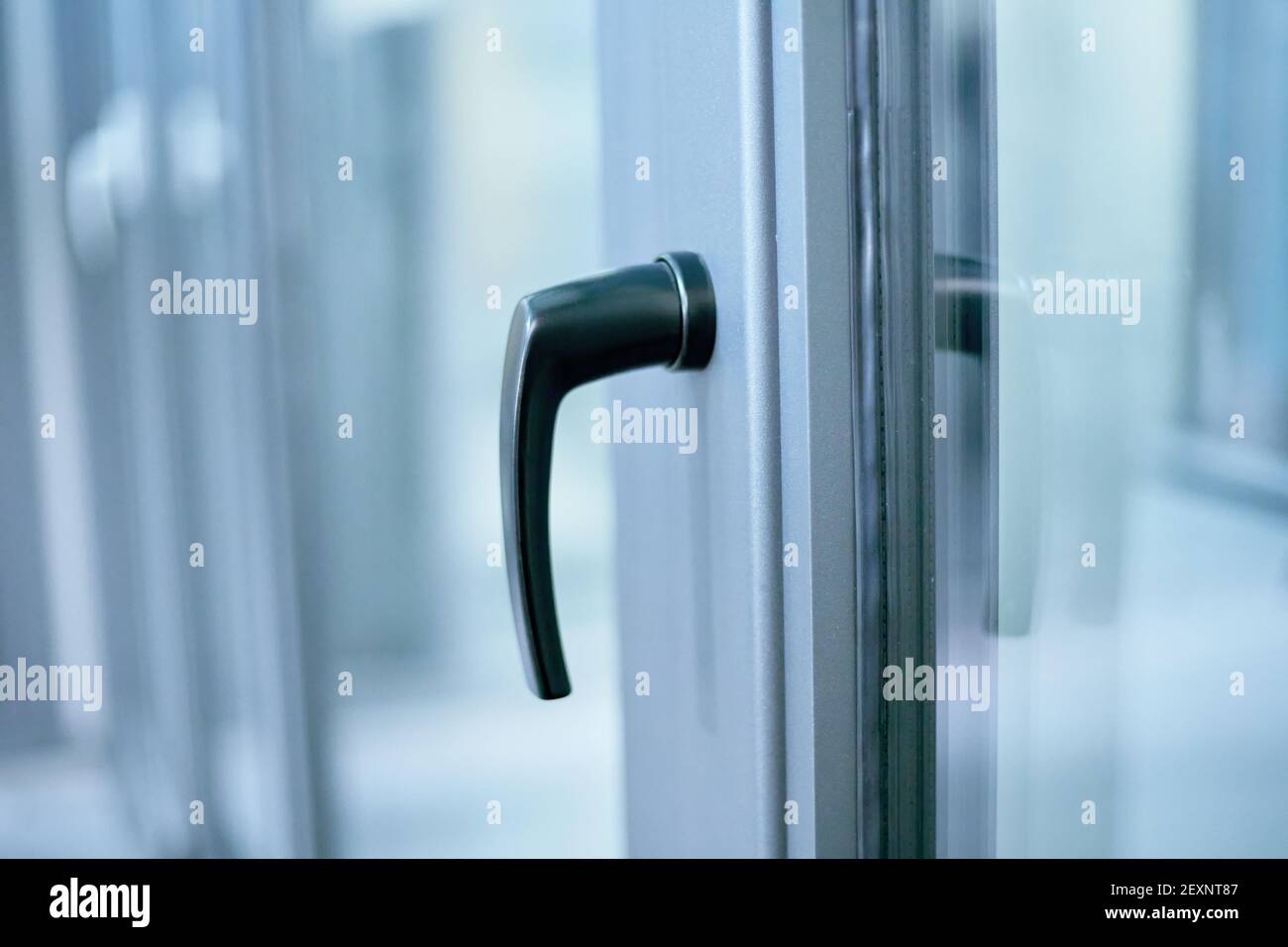 stylish metal handle on the window frame Stock Photo - Alamy