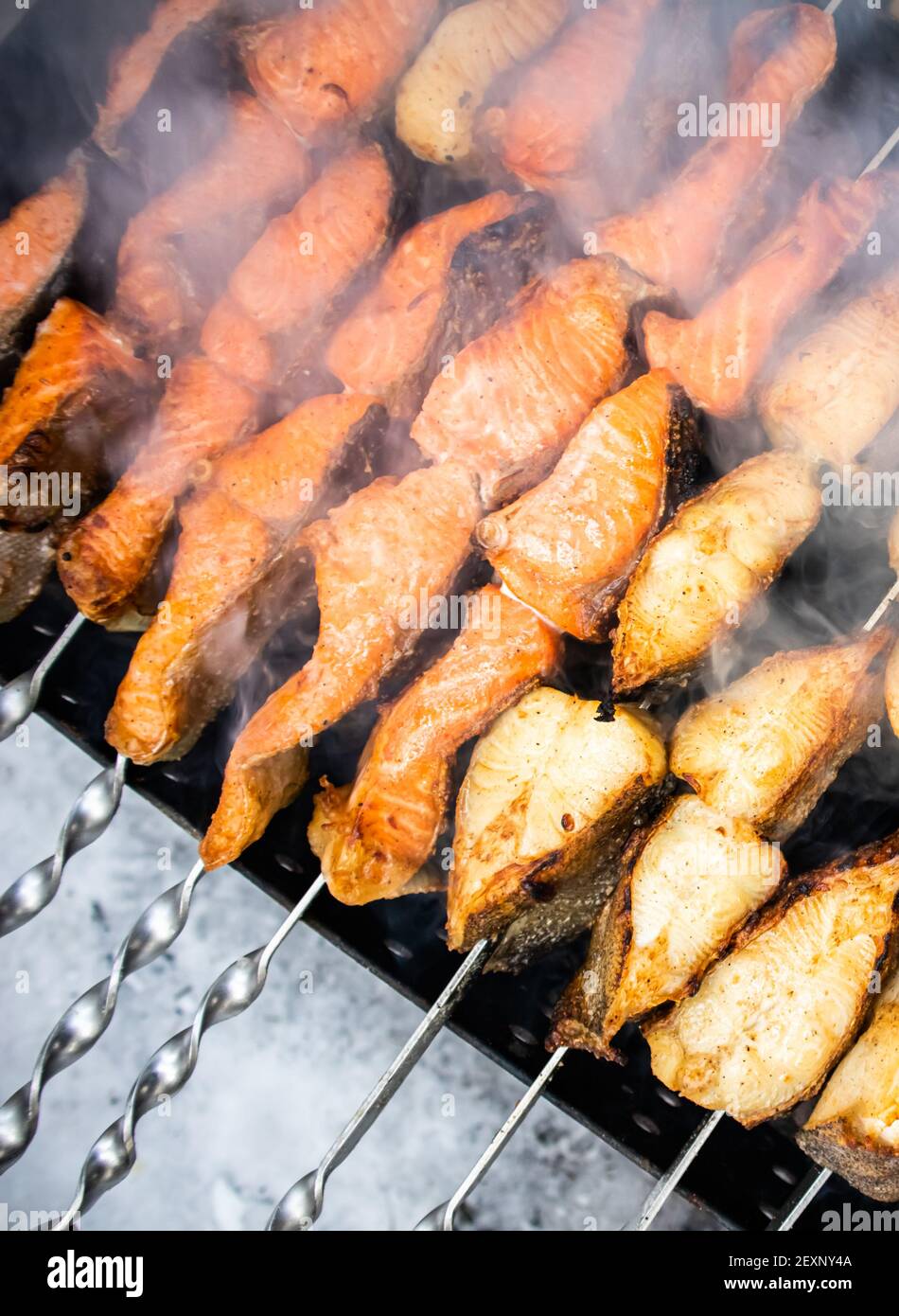 Fish kebab on skewers on the grill in winter. Salmon and halibut Stock ...