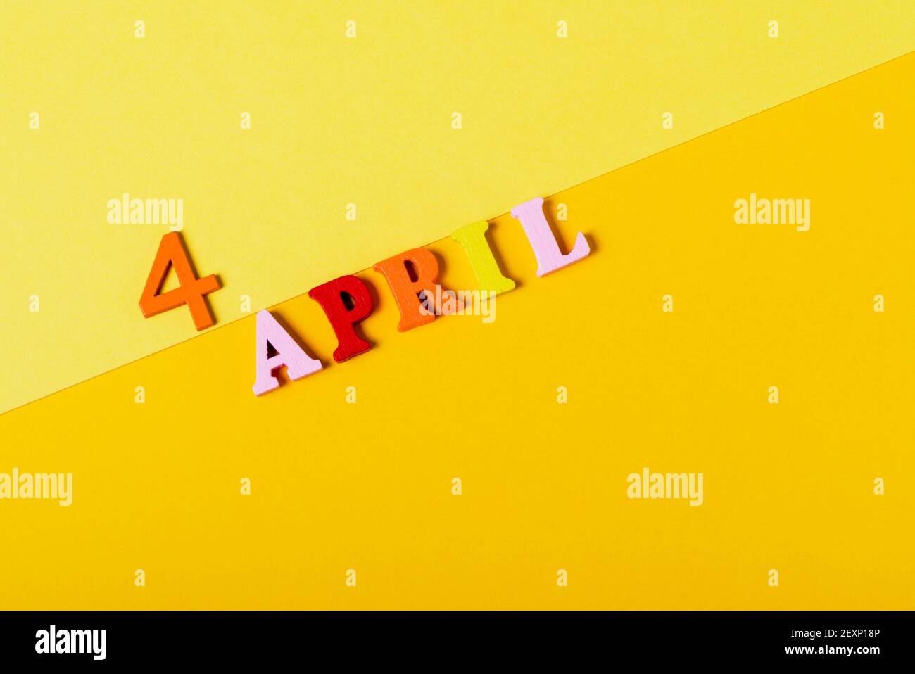 Wooden letters of the fourth of April on a yellow background. Qing Ming ...