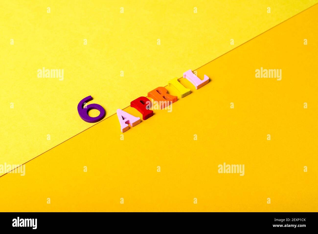 Wooden letters of the sixth of April on a yellow background ...