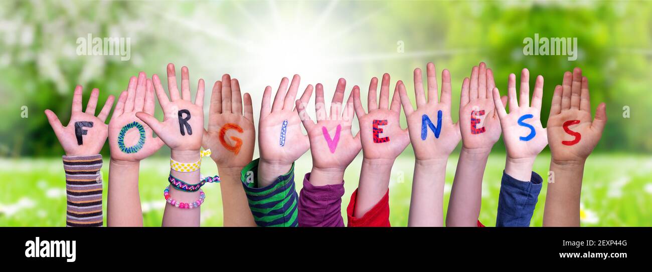 Children Hands Building Word Forgiveness, Grass Meadow Stock Photo - Alamy