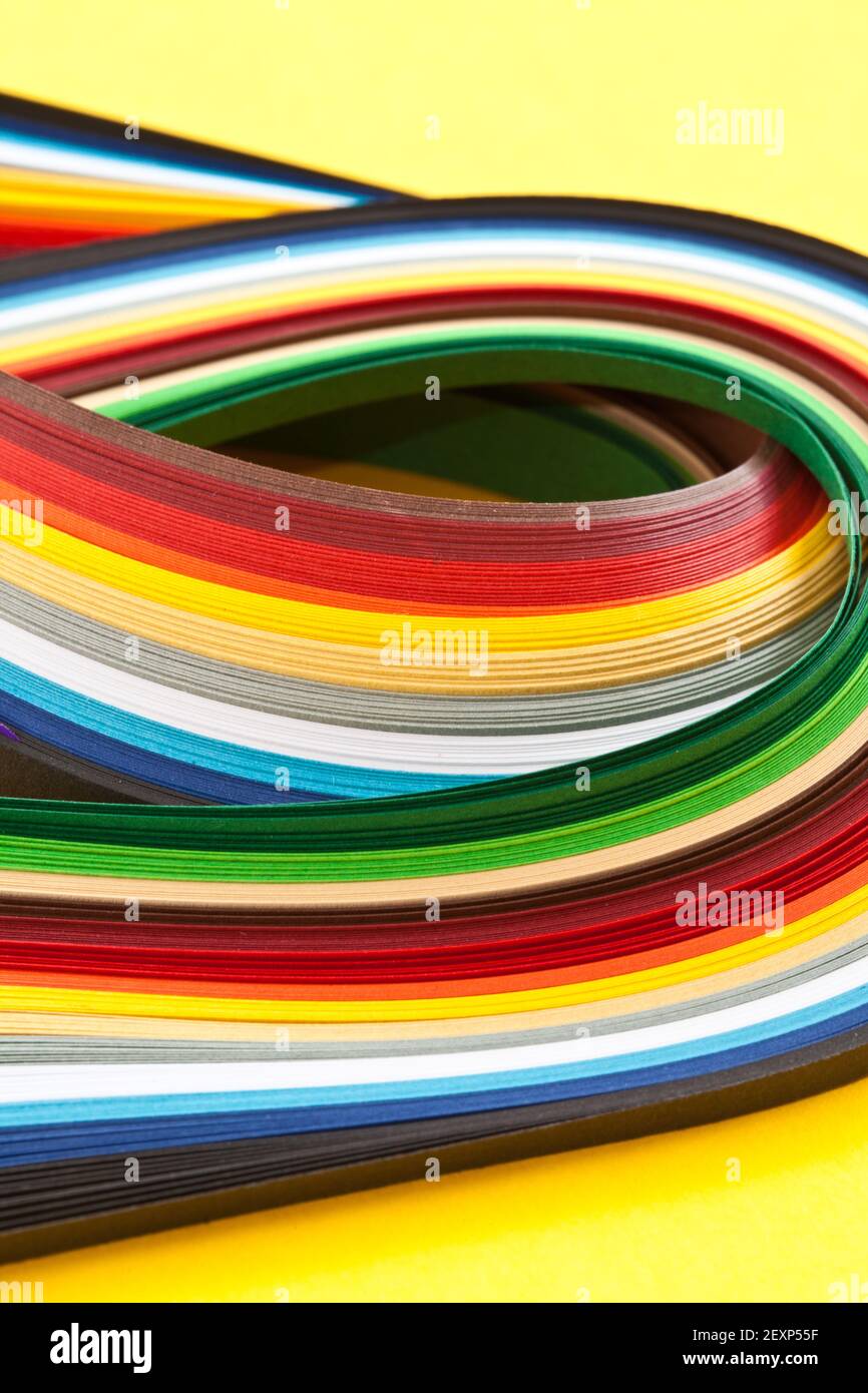 Colorful paper strips on yellow Stock Photo - Alamy