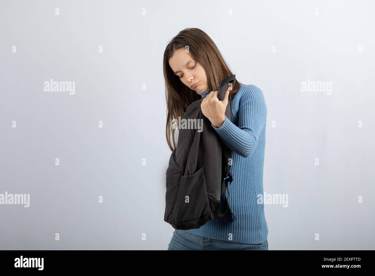 Portrait photo of a young girl model holding backpack and posing Stock ...