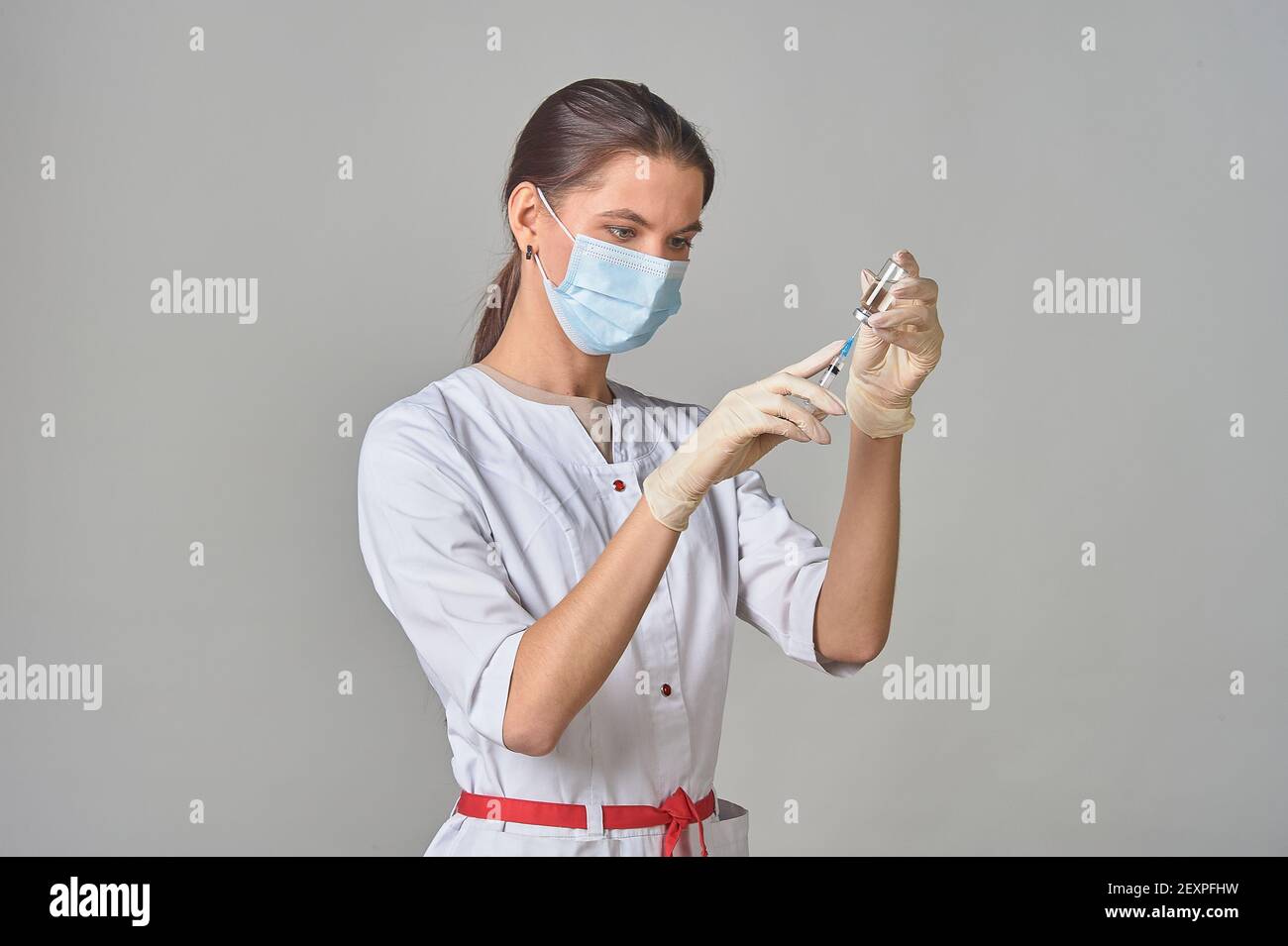 A nurse taking medicine into a syringe from a bottle close-up Stock ...