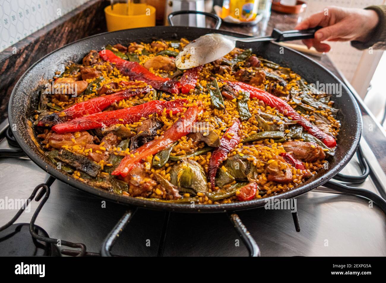 A beautiful shot of a Spanish rice dish named Paella on a gas stove ...