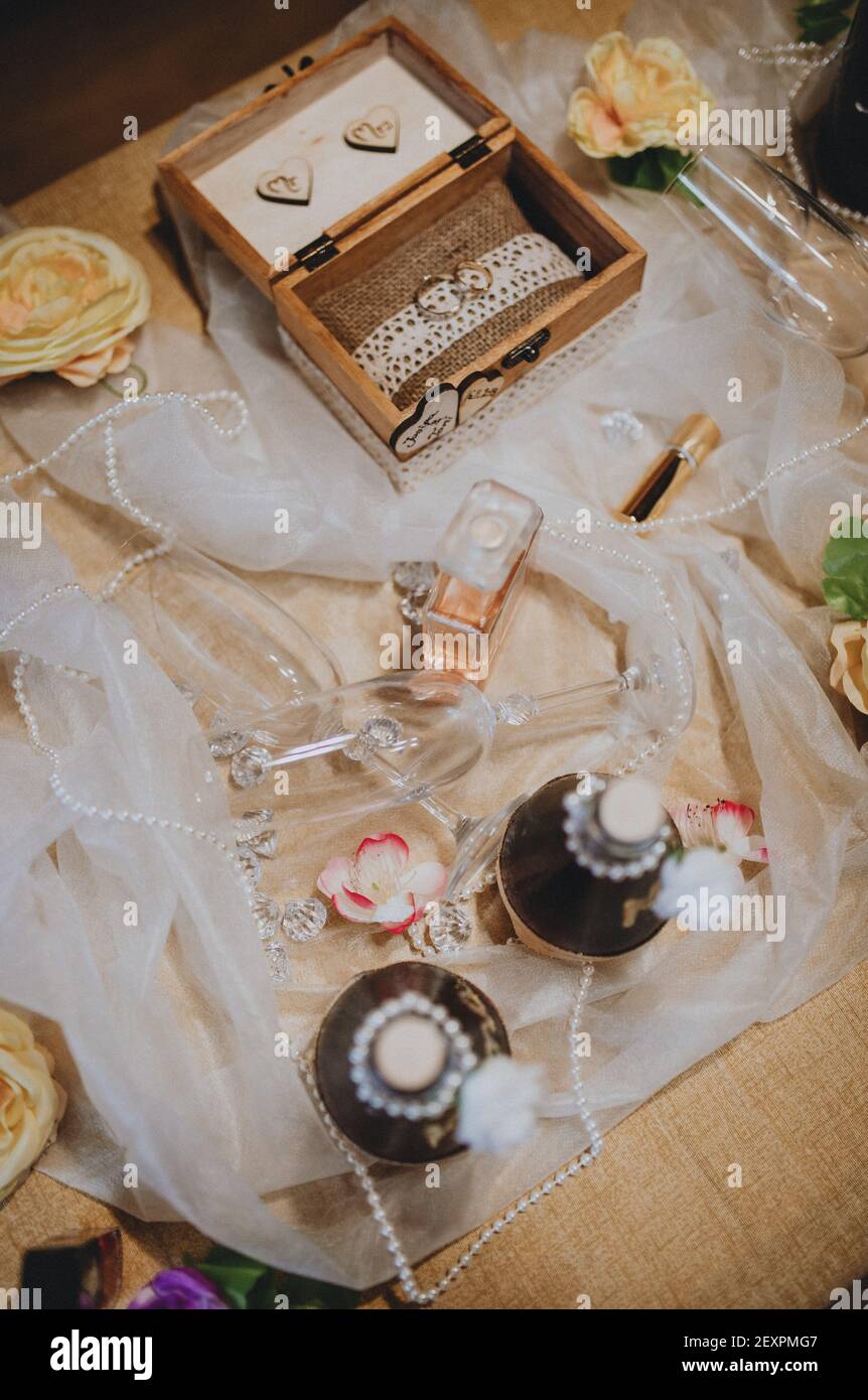 A vertical high angle shot of wedding rings and other wedding-related ...