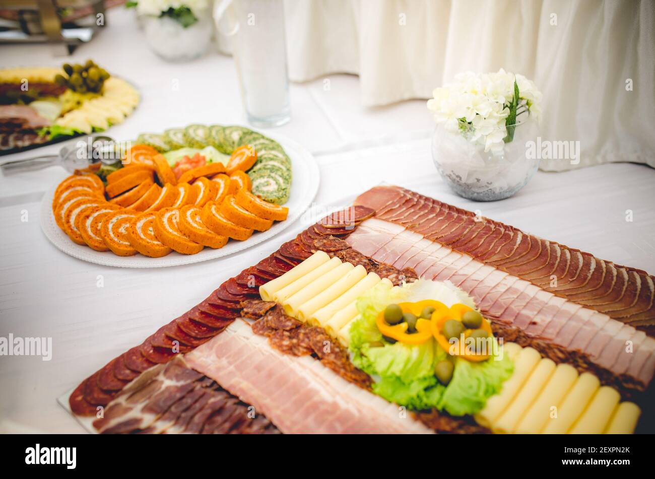 A closeup of delicious finger foods and salami on a table for an event ...
