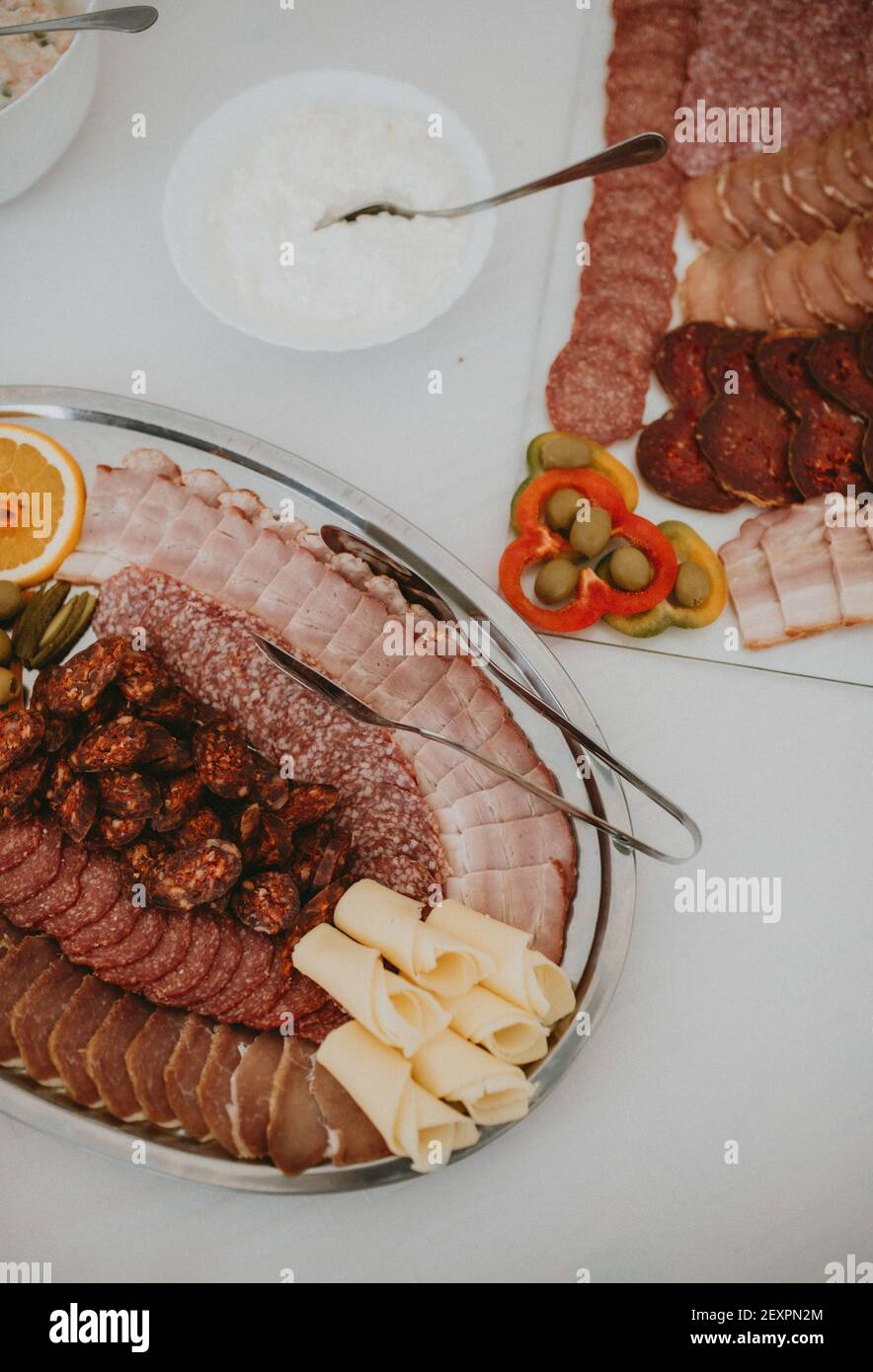 A vertical high angle shot of delicious finger foods and salami on a ...