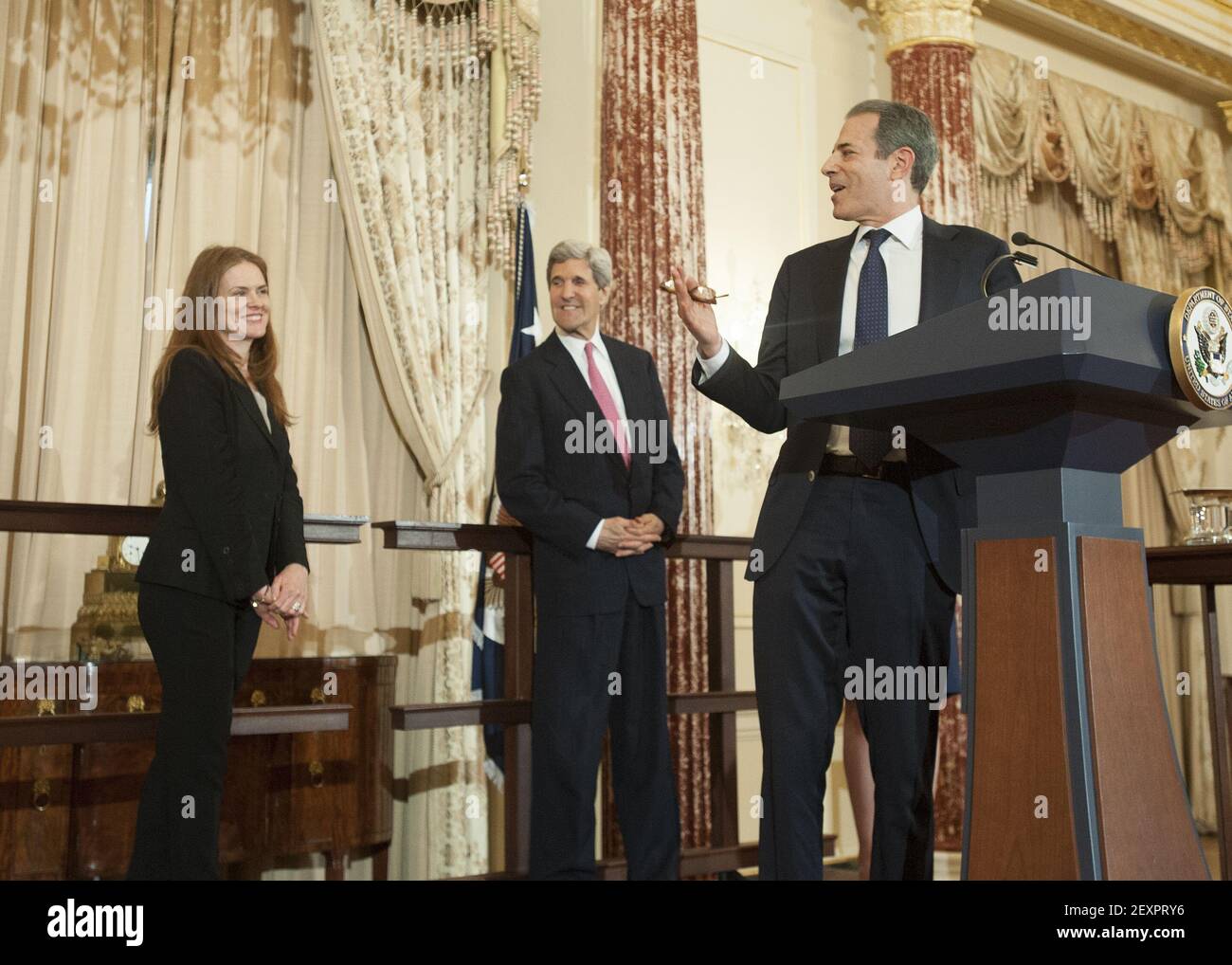 Looking back at his wife, Mary Pfaff, and U.S. Secretary of State John ...