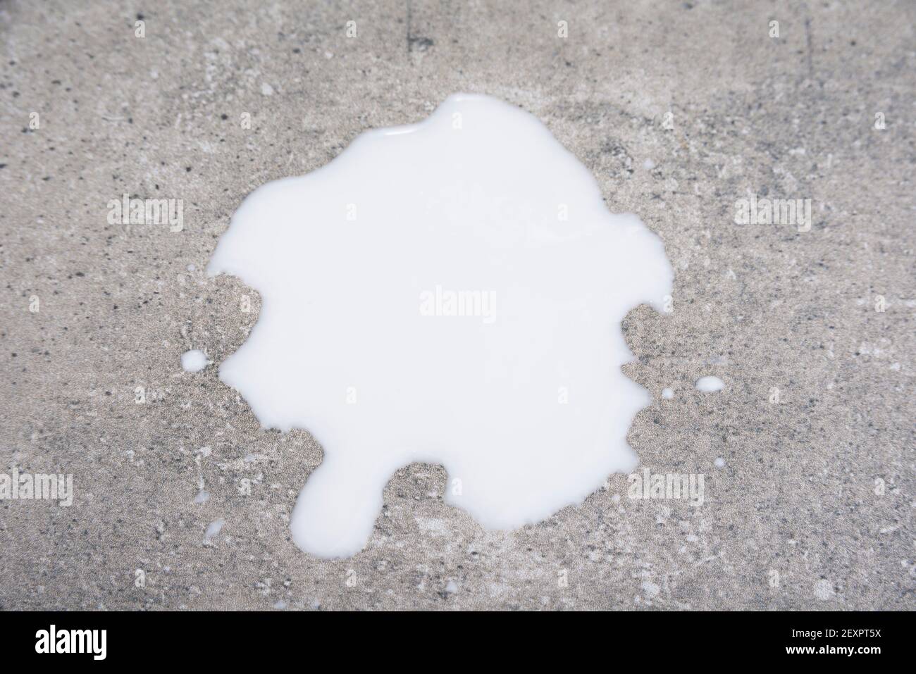 Milk spill on a kitchen desk Stock Photo - Alamy