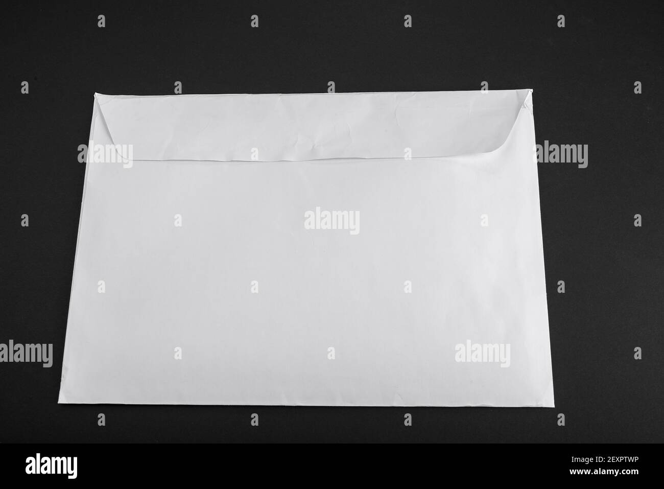 Used white A4 envelope on a black background Stock Photo - Alamy