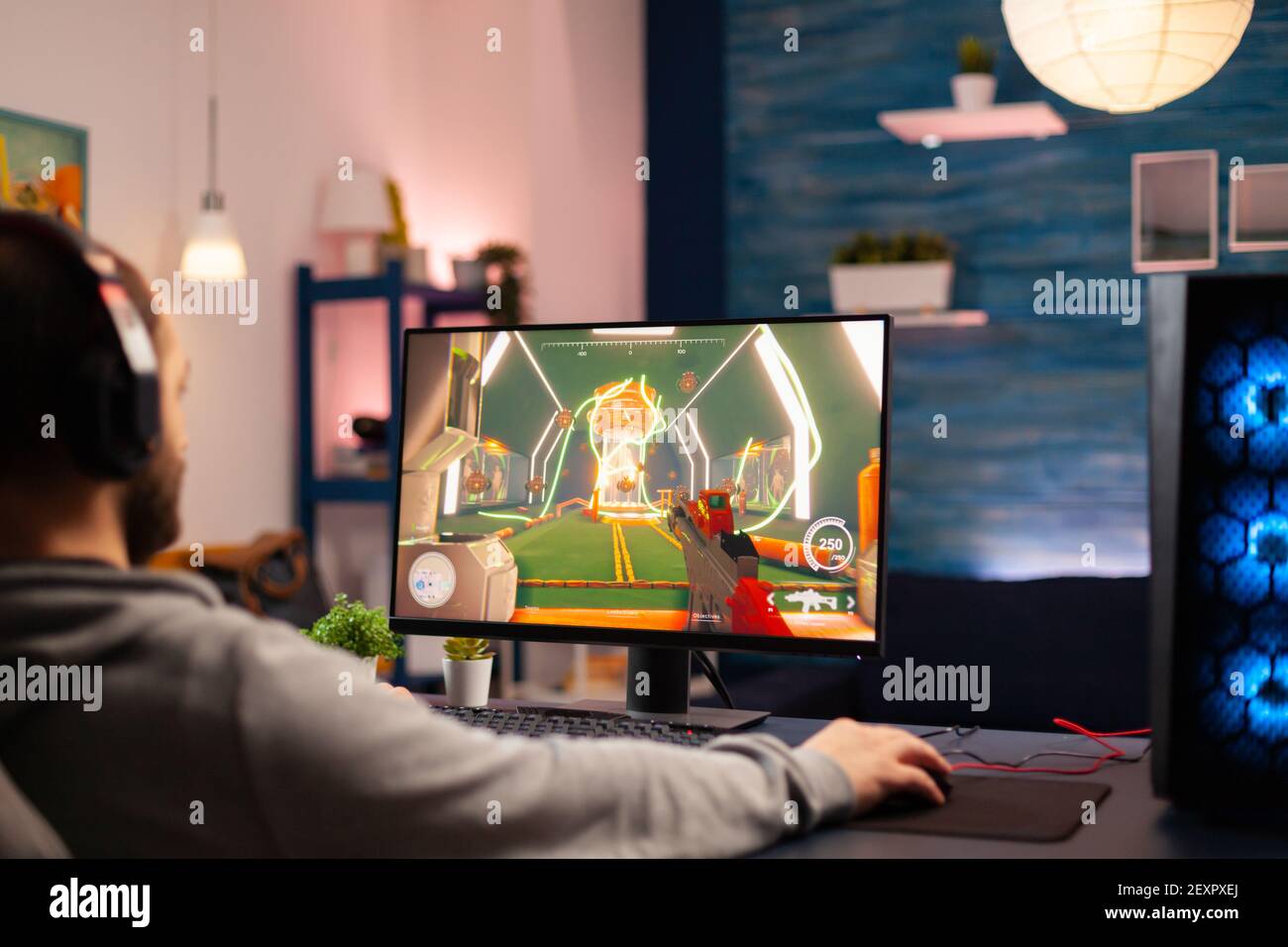 Pro virtual gamer wearing headphones playing video games at ...