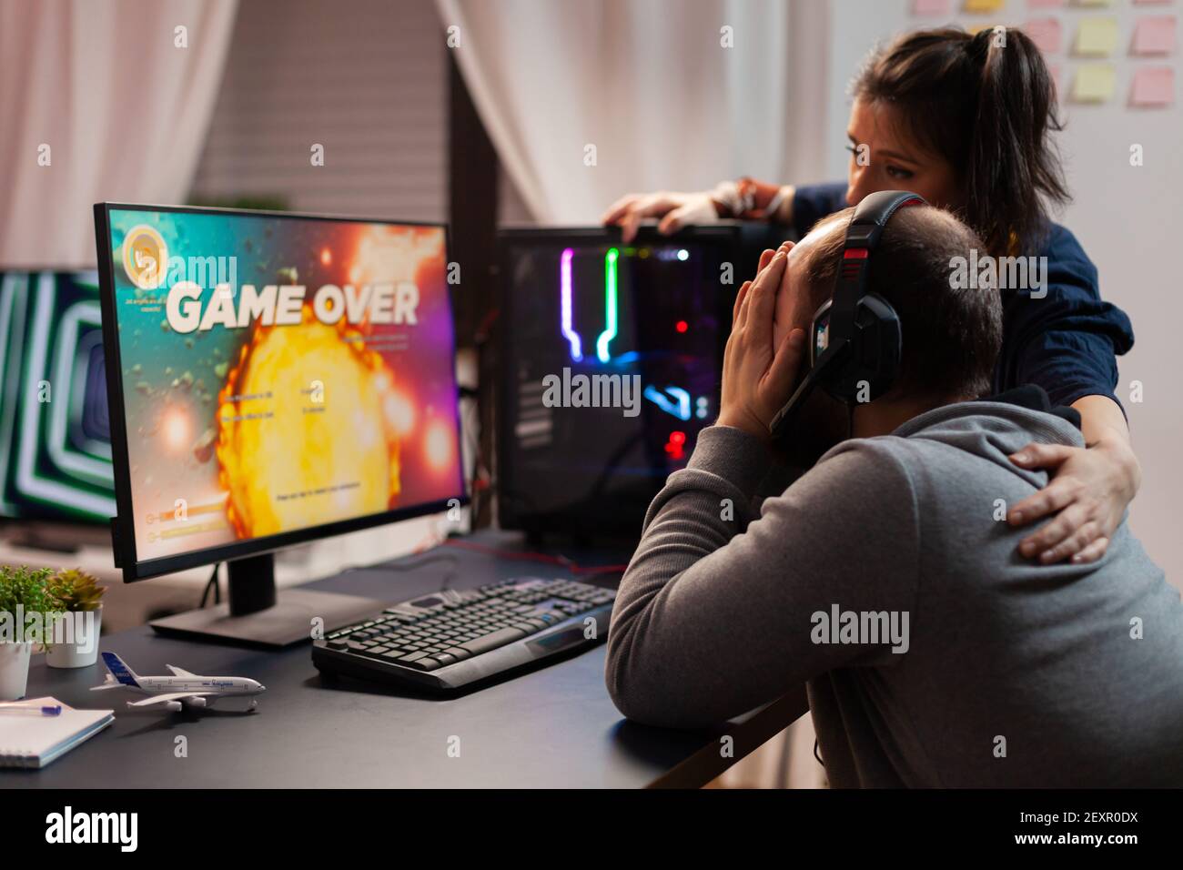 Side view of game over for pro player couple, playing space shooter ...