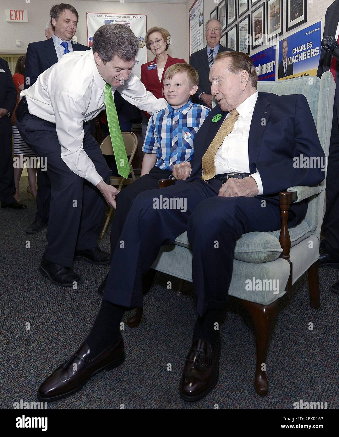 Kansas Gov. Sam Brownback helps Henry Walston, 10, from Lenexa, Kan ...