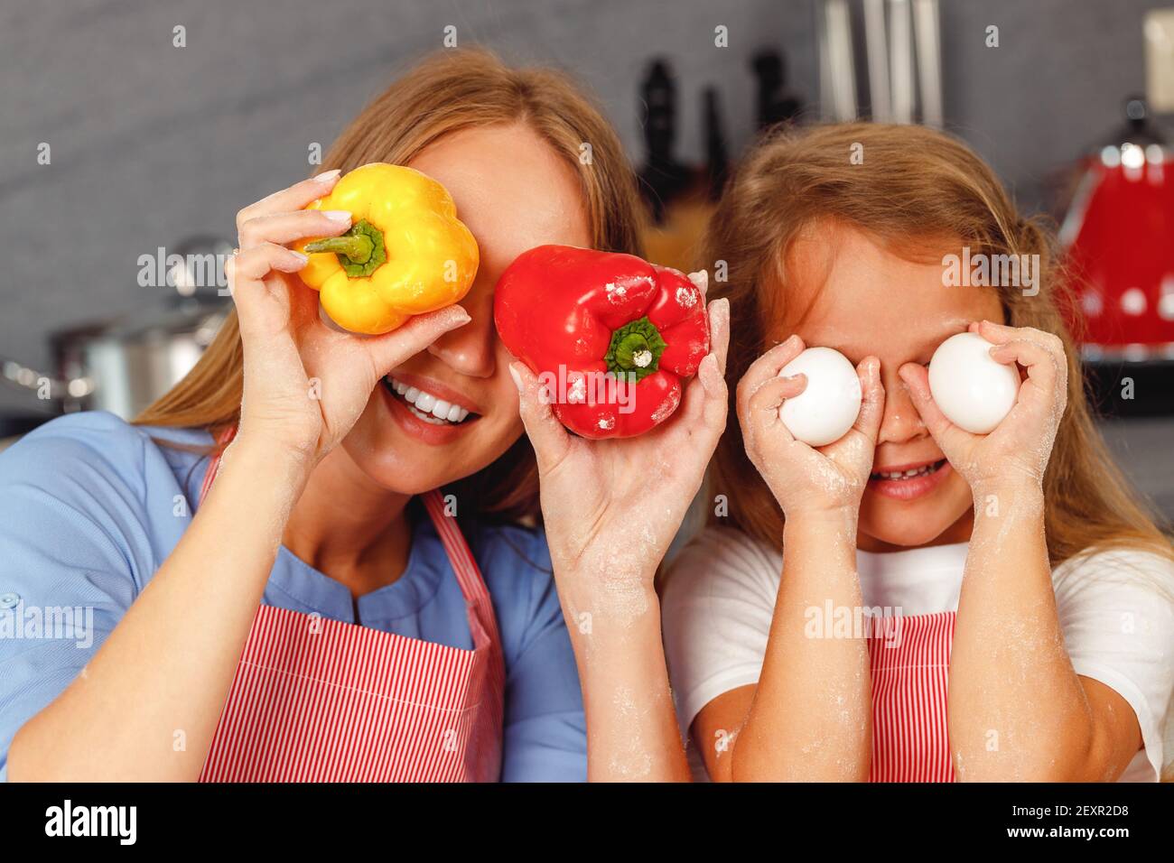 Mother and daughter having fun with food while cooking in kitchen Stock ...