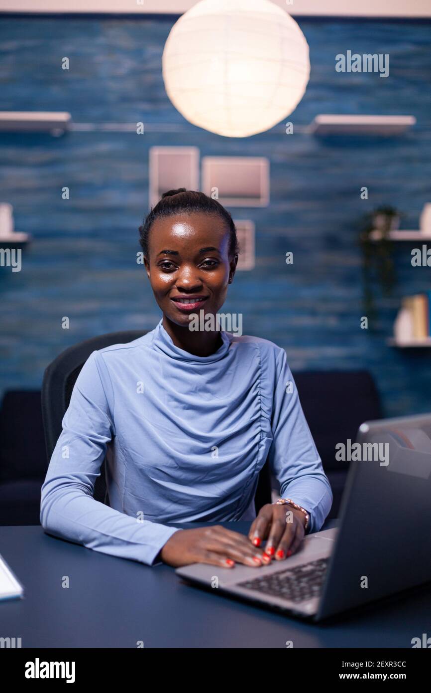 Overworked african entrepreneur sitting at office table in living room ...