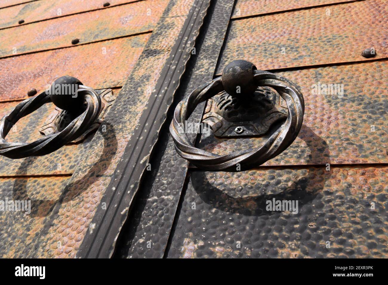 Old riveted iron door.Metal handles Stock Photo - Alamy