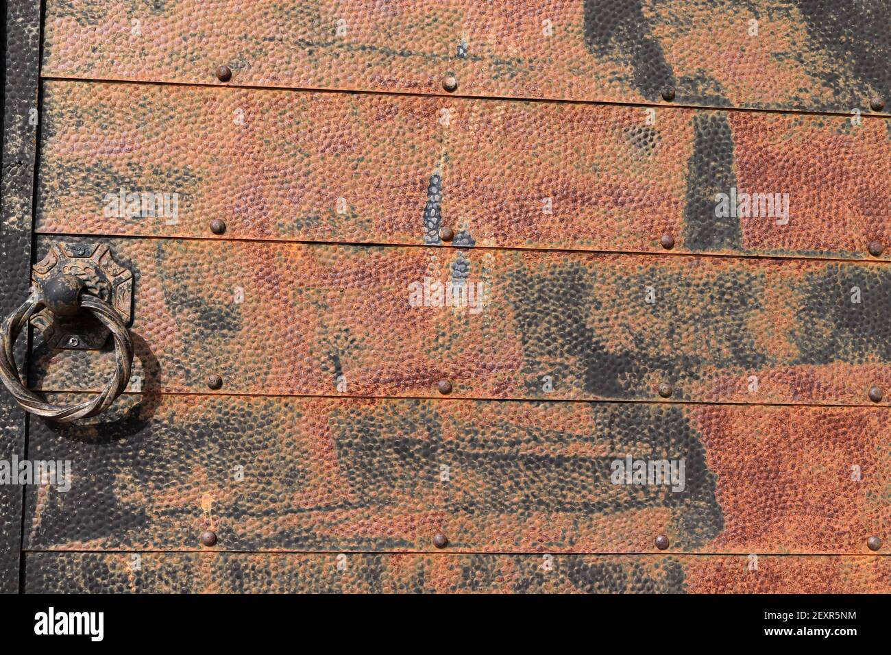 Old riveted iron door.Metal handles Stock Photo - Alamy