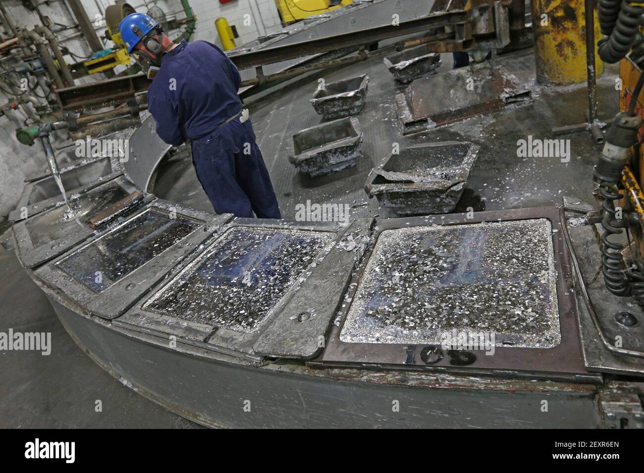 Gopher Resource employee Tracy Bennett pours melted lead from recycled ...