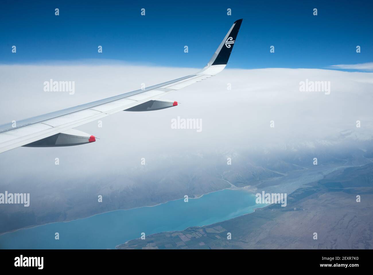 An Air New Zealand flight flying over Lake Pukaki in heavy fog. Image ...