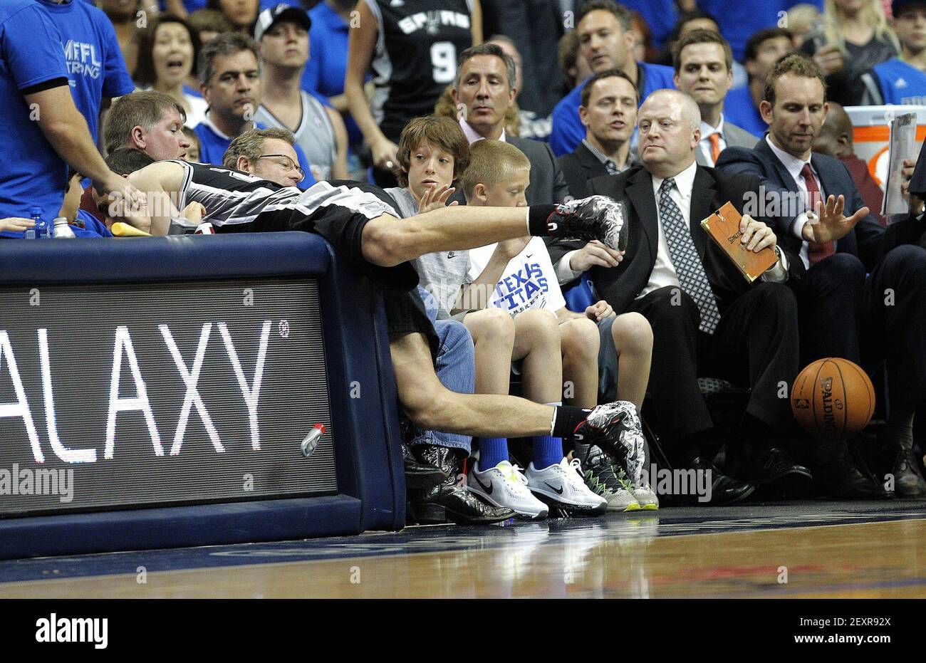The San Antonio Spurs' Manu Ginobili dives across the scorer's table ...