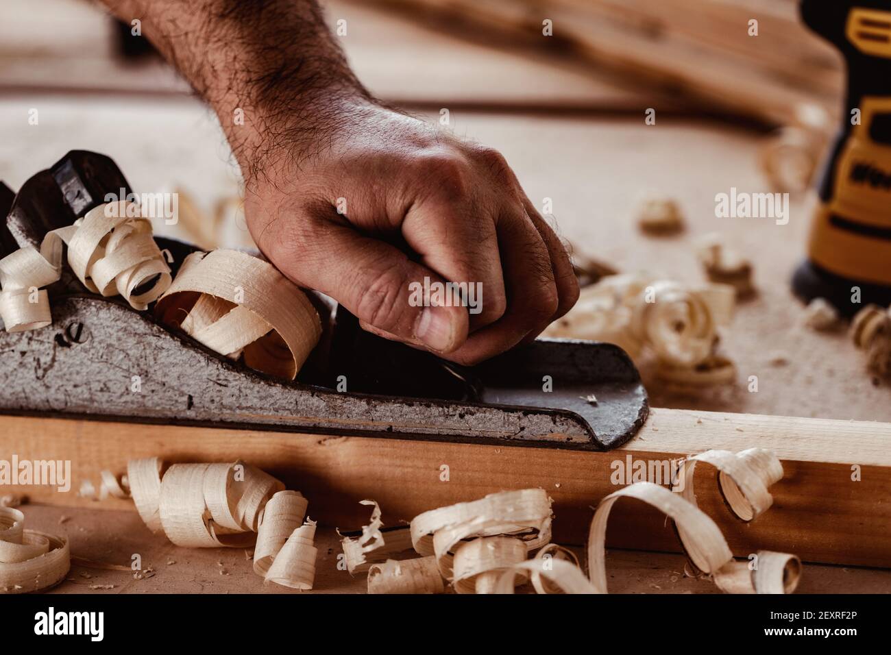 Carpenter's hands planing a plank of wood with a hand plane Stock Photo ...
