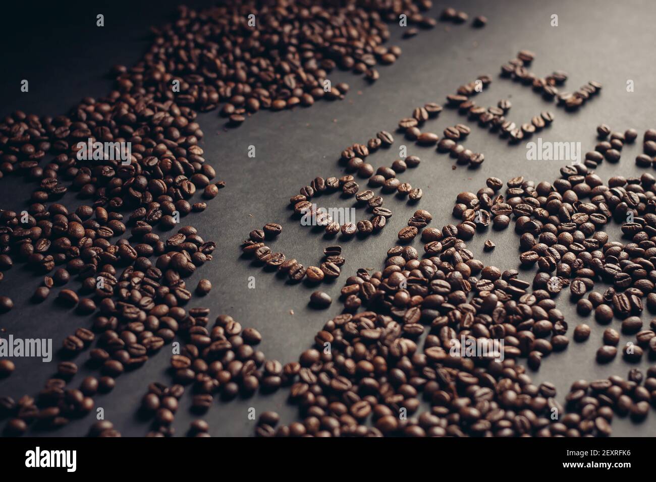 word from coffee beans on gray background close-up drink arabica ...