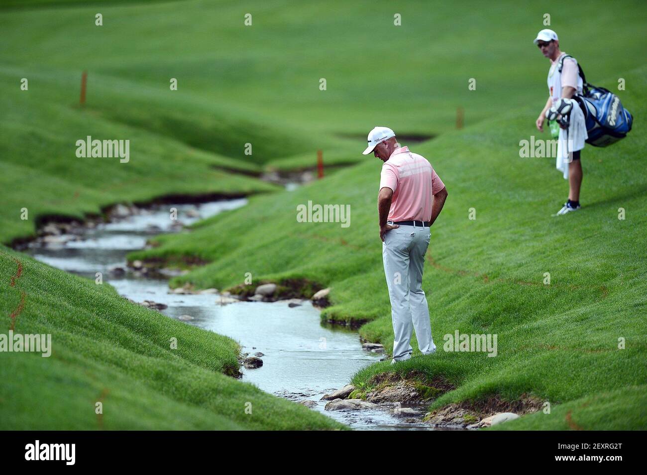 Stewart Cink looks at his ball in the creek in the 18th fairway during ...