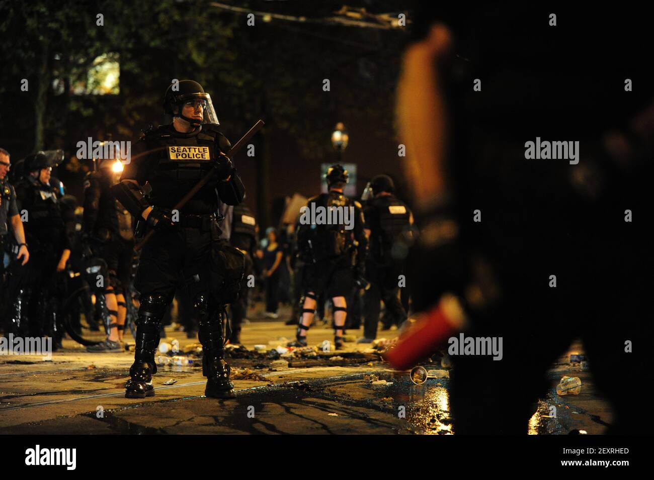 A police officer in riot gear stands guard outside of Seattle Central ...