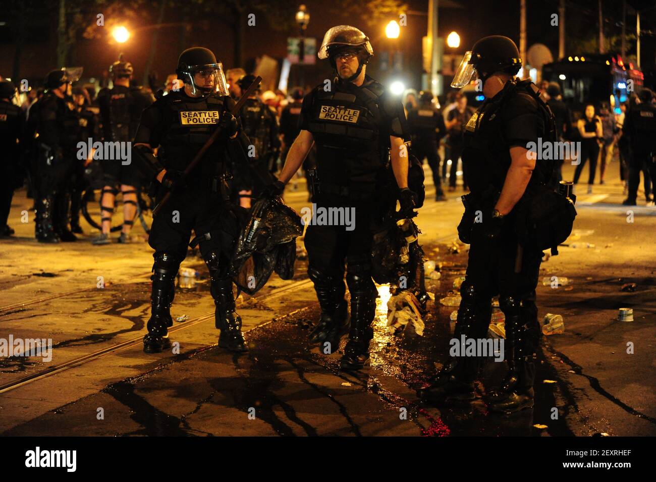 Police clean up the trash can fire set alight by anti-capitalist ...