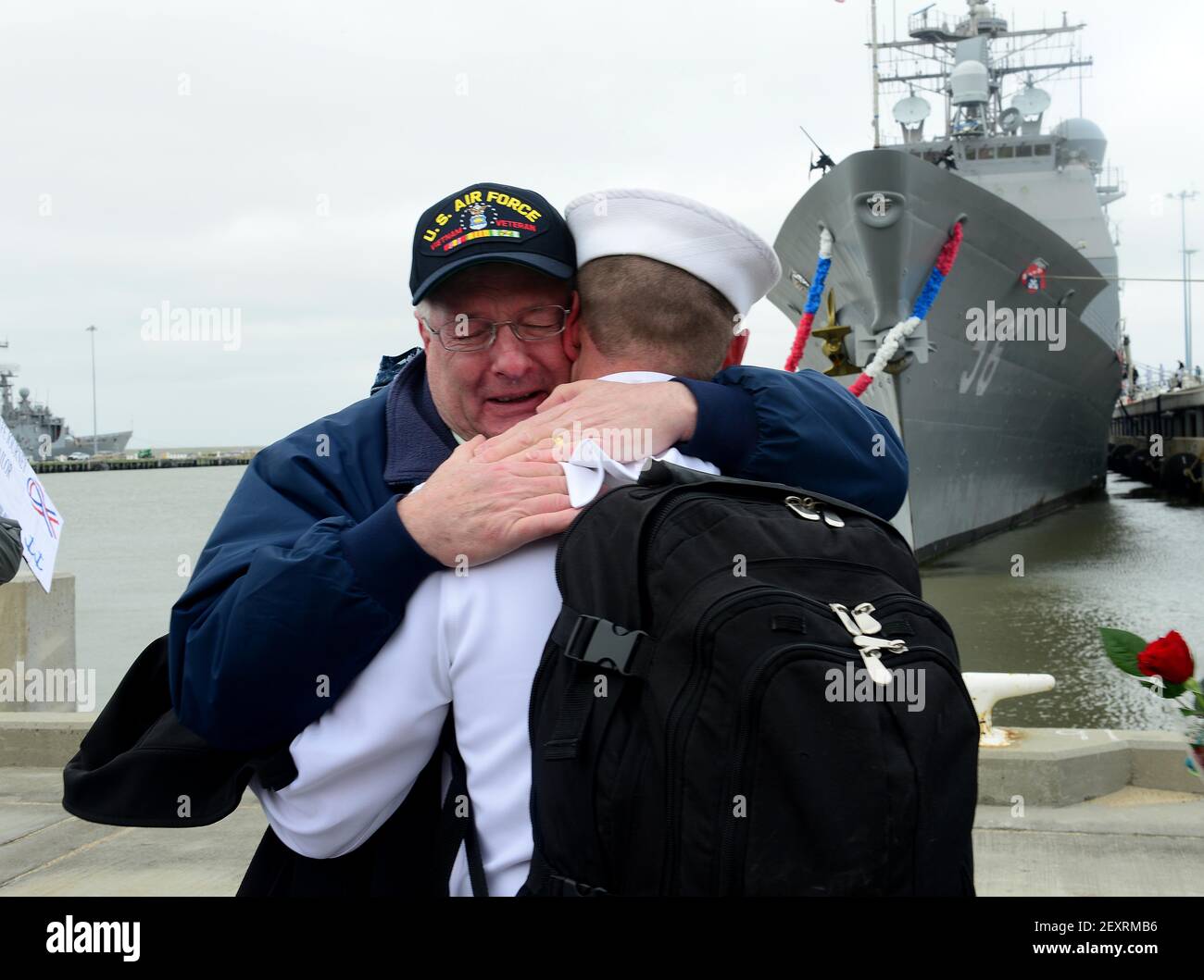 U.S. Navy Fire Controlman 2nd Class Mark Peters, right, embraces his ...