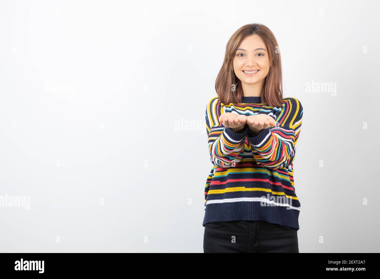 Portrait photo of a young woman model showing opened palms Stock Photo ...
