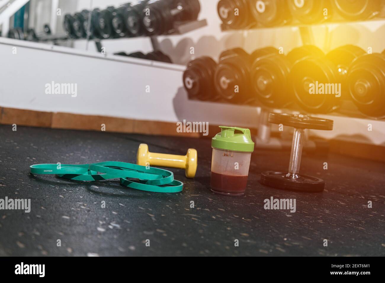 Protein shake and dumbbells at the gym. Fitness nutrition drink and ...