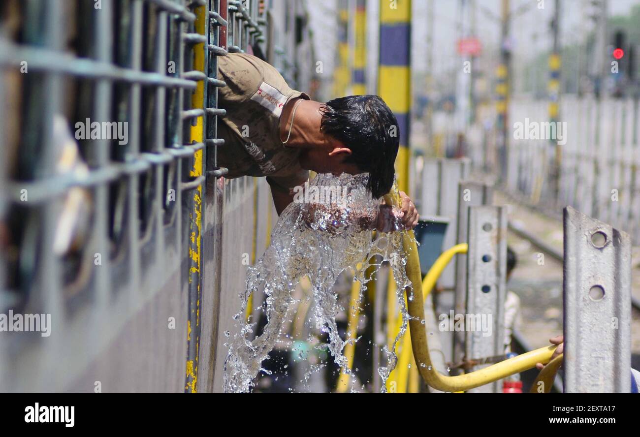 A commuter pours water over his head to cool off from train emergency ...