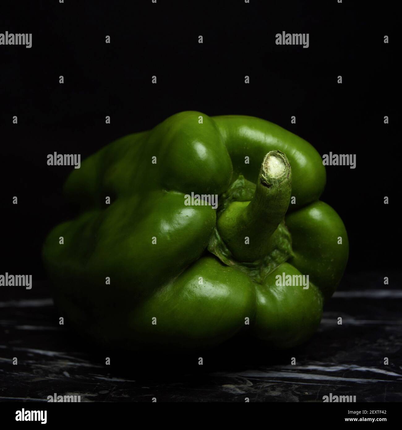A closeup shot of green bell pepper on a black background Stock Photo ...