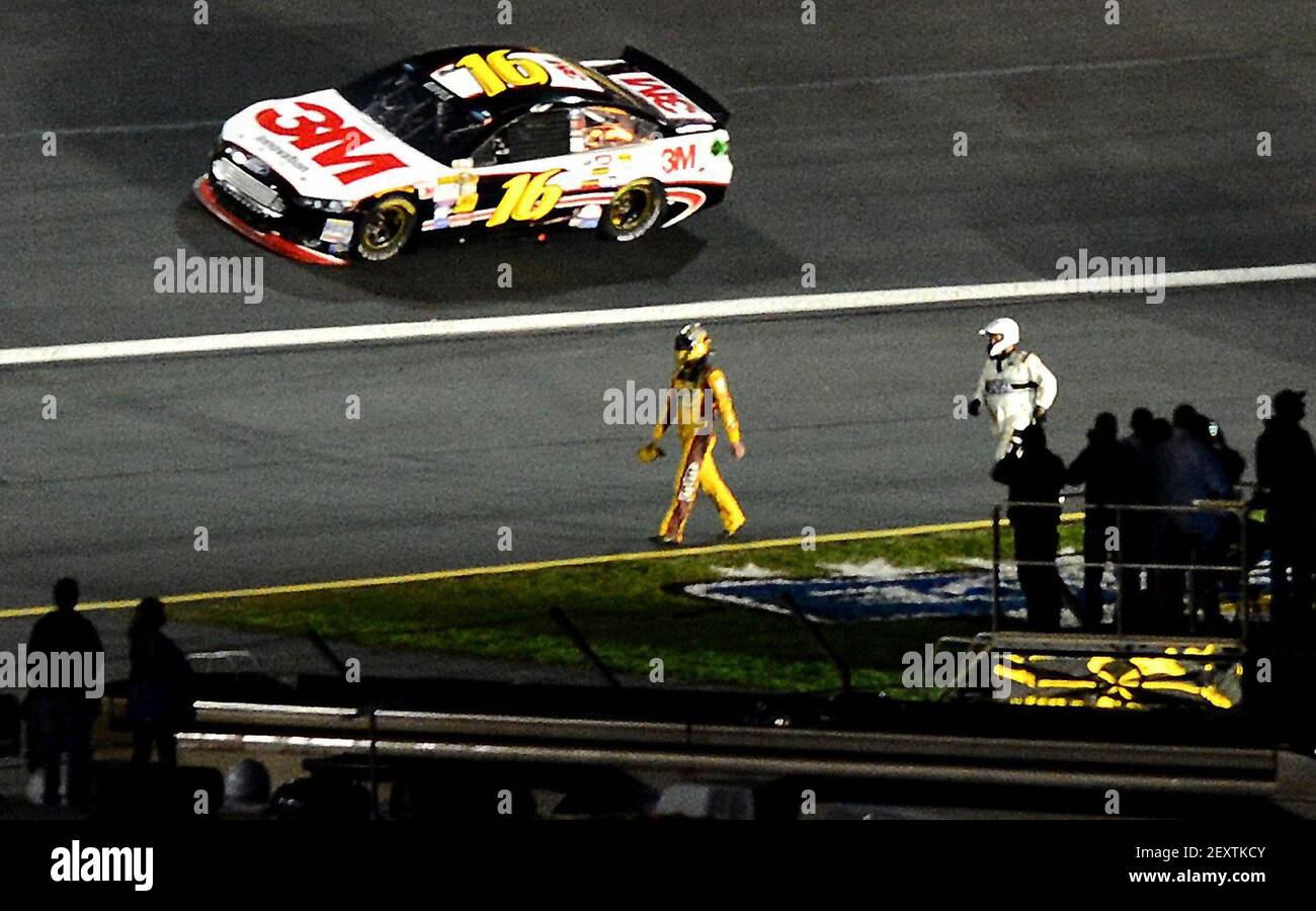 A NASCAR Sprint Cup safety worker rushes after driver Kyle Busch (18 ...