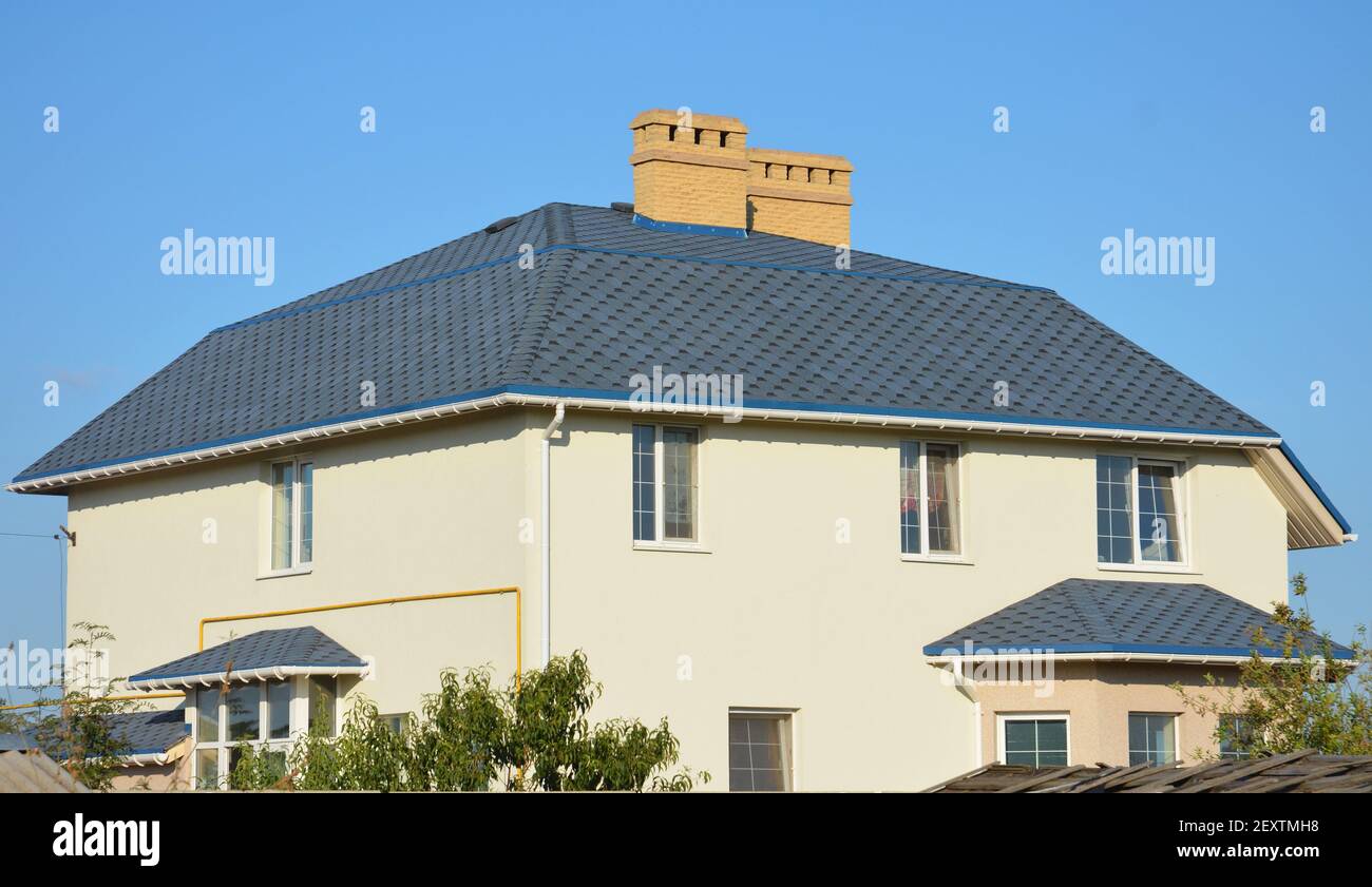 Facade of a large mansion, house with an asphalt shingled roof with a ...